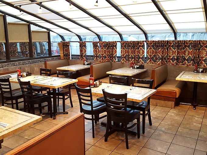 Classic diner ambiance with a twist&mdash;patterned curtains and comfortable booths create that perfect "stay awhile" atmosphere where breakfast dreams come true.