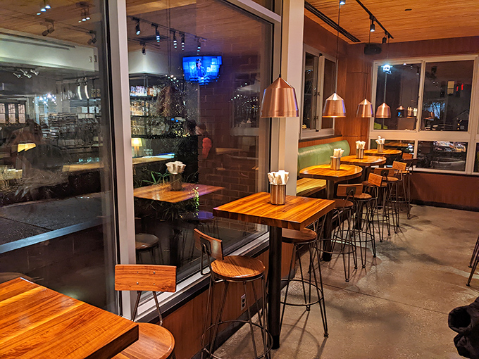 Warm wooden tables and copper pendant lights create that rare atmosphere where both first dates and business meetings feel equally at home.