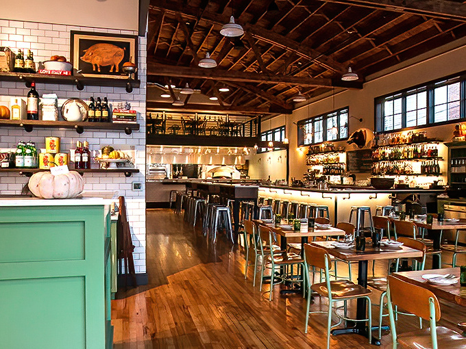 The interior feels like that perfect Italian film set&mdash;exposed beams above, polished wood below, and everywhere the promise of something delicious about to happen.