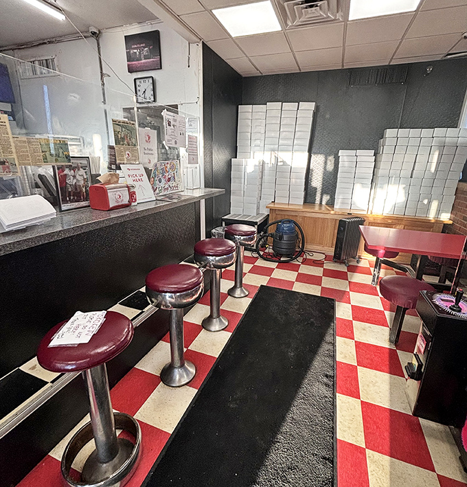 Classic red and white checkered floors and vintage counter stools &ndash; this isn't interior design, it's time travel with sprinkles on top.