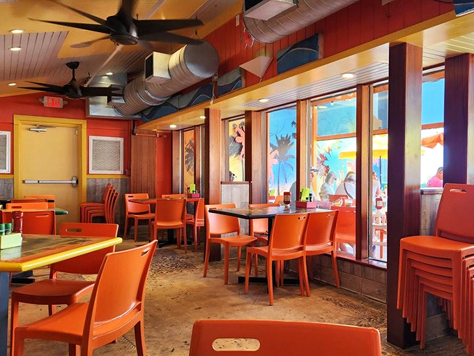 Inside, vibrant orange chairs and warm wood tones create that perfect "I'm on vacation even though I live here" Florida vibe.