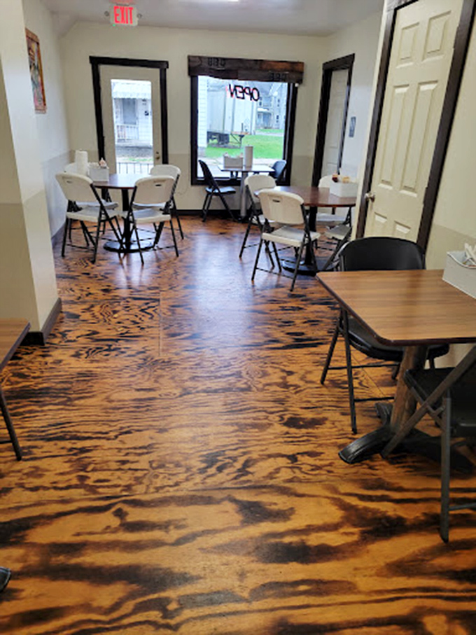 Simple tables, distinctive wood-patterned floors, and an atmosphere that whispers, "We're serious about barbecue, not fancy furniture."