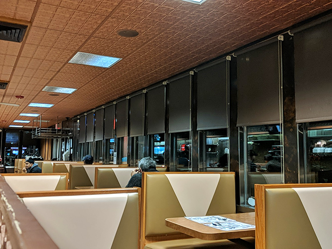 Vinyl booths and pressed tin ceilings transport you to simpler times. The quintessential diner interior where conversations flow as freely as the coffee.