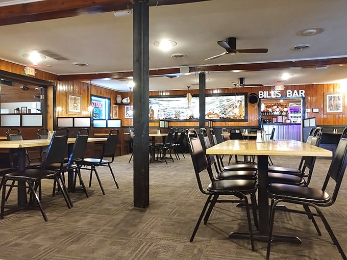Classic wood-paneled walls and comfortable seating create that "I've found my happy place" feeling. Bill's Bar beckons in the background.
