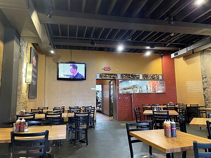 Industrial-chic meets comfort at Redsmoke's dining room. Those wooden tables have witnessed countless barbecue epiphanies and sauce-stained smiles.