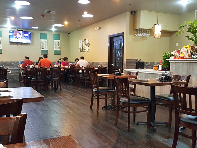 Simple wooden tables and practical chairs set the stage where the food, not the decor, plays the starring role in this culinary theater.