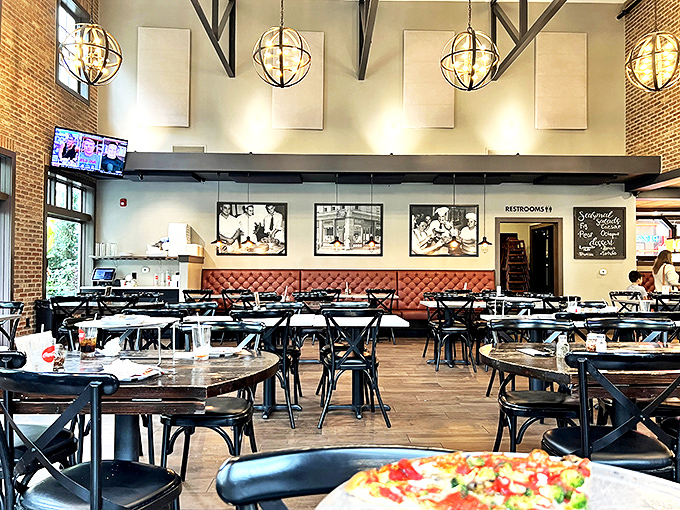 High ceilings, exposed beams, and those globe pendant lights create the perfect stage for tomato pie drama. Dinner and a show, folks!