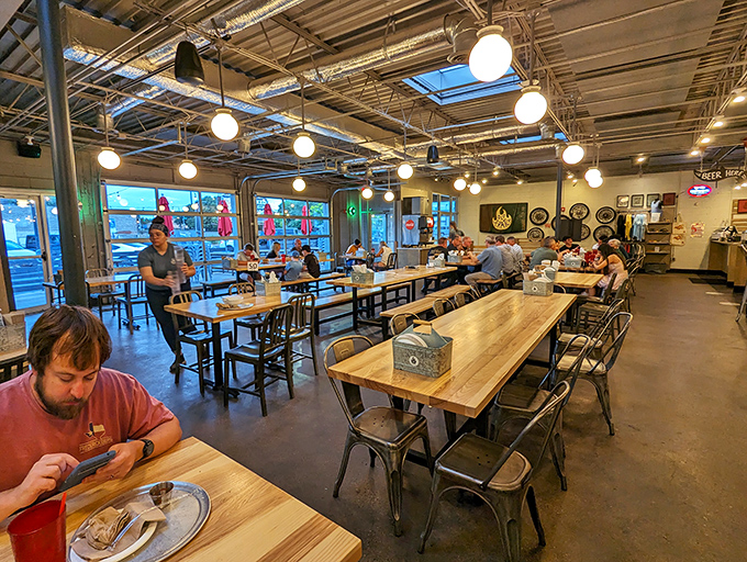 Communal tables and industrial-chic vibes create the perfect backdrop for pizza pilgrims. Edison bulbs cast that "everyone looks good enough to be in a food documentary" glow.
