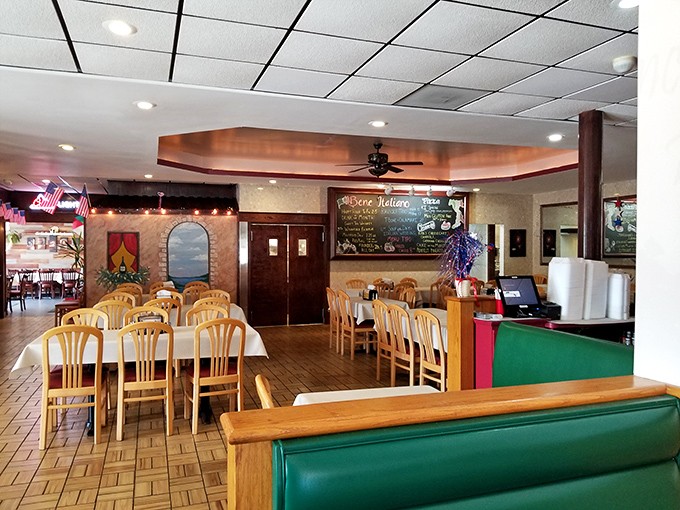 Simple wooden tables, green booths, and Italian-themed decor create that perfect neighborhood restaurant atmosphere where conversations flow as freely as the marinara.
