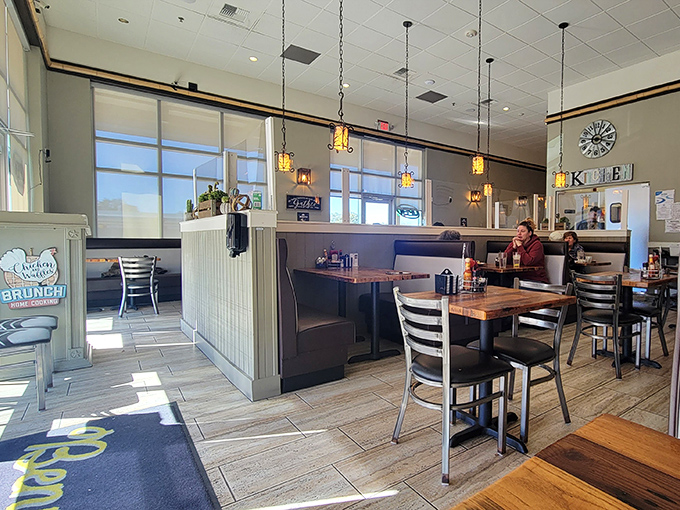 Sunlight streams through windows illuminating wooden tables and pendant lights, creating that perfect "I could stay here all morning" atmosphere.