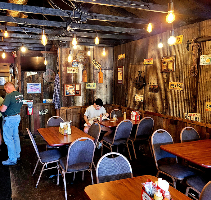 Edison bulbs and license plates create the perfect ambiance for serious meat consumption. This isn't interior design&mdash;it's barbecue atmosphere engineering at its finest.