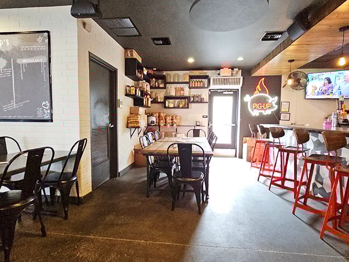 Industrial-chic meets comfort in this cozy interior. The "PIG UP" neon sign isn't just decor&mdash;it's solid life advice for barbecue enthusiasts.