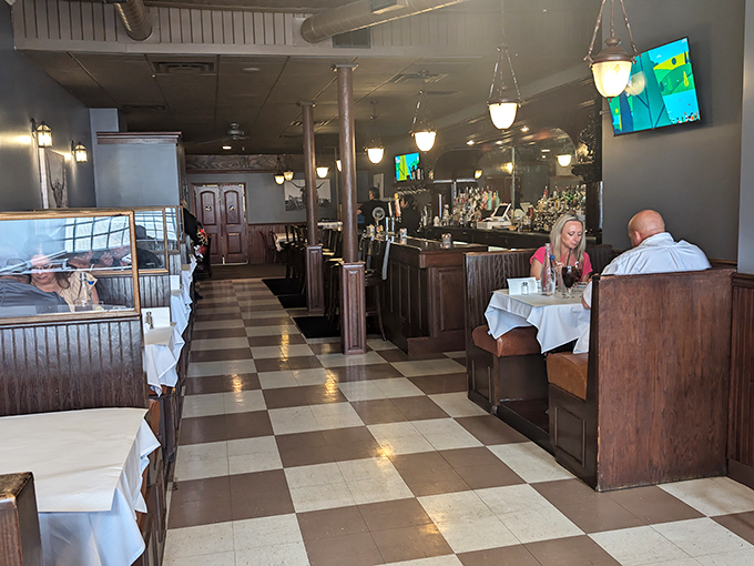 Classic checkerboard floors and warm wooden booths create that perfect "where everybody knows your name" vibe. The kind of place where memories are made between bites.