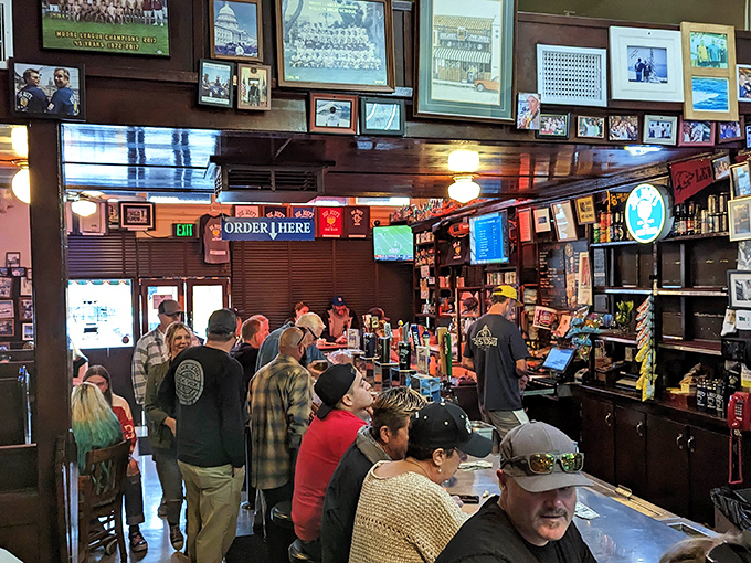 Step inside where decades of laughter echo off walls lined with authentic memories.