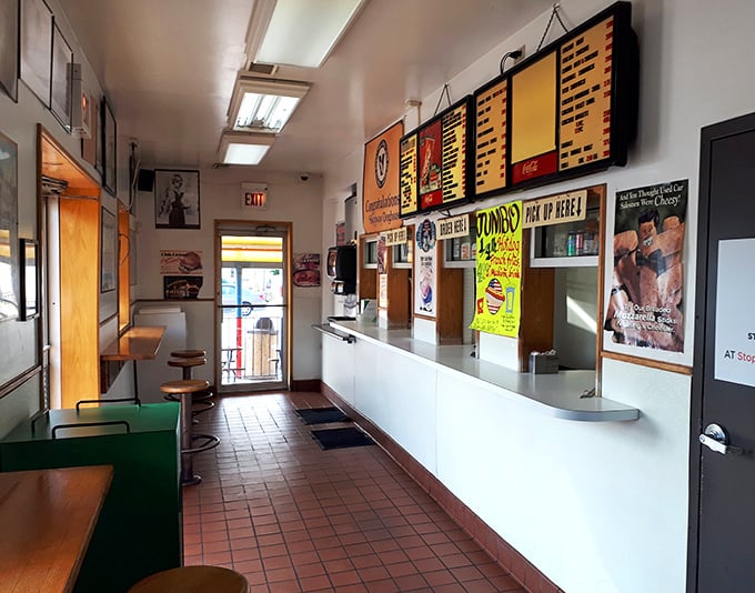 No-frills interior where culinary magic happens. The menu board promises Chicago classics while the tile floor has supported decades of hungry patrons.