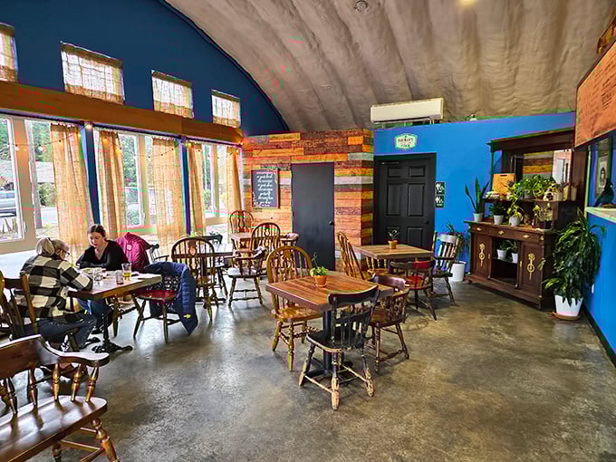 Mismatched wooden chairs and vibrant blue walls create that rare atmosphere where comfort meets character. Like your coolest friend's living room, but with better food.