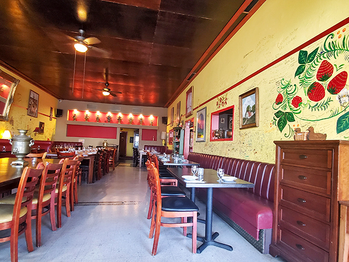 Yellow walls adorned with folk art and burgundy banquettes create a warm embrace, like stepping into a Tbilisi dining room rather than a San Diego restaurant.