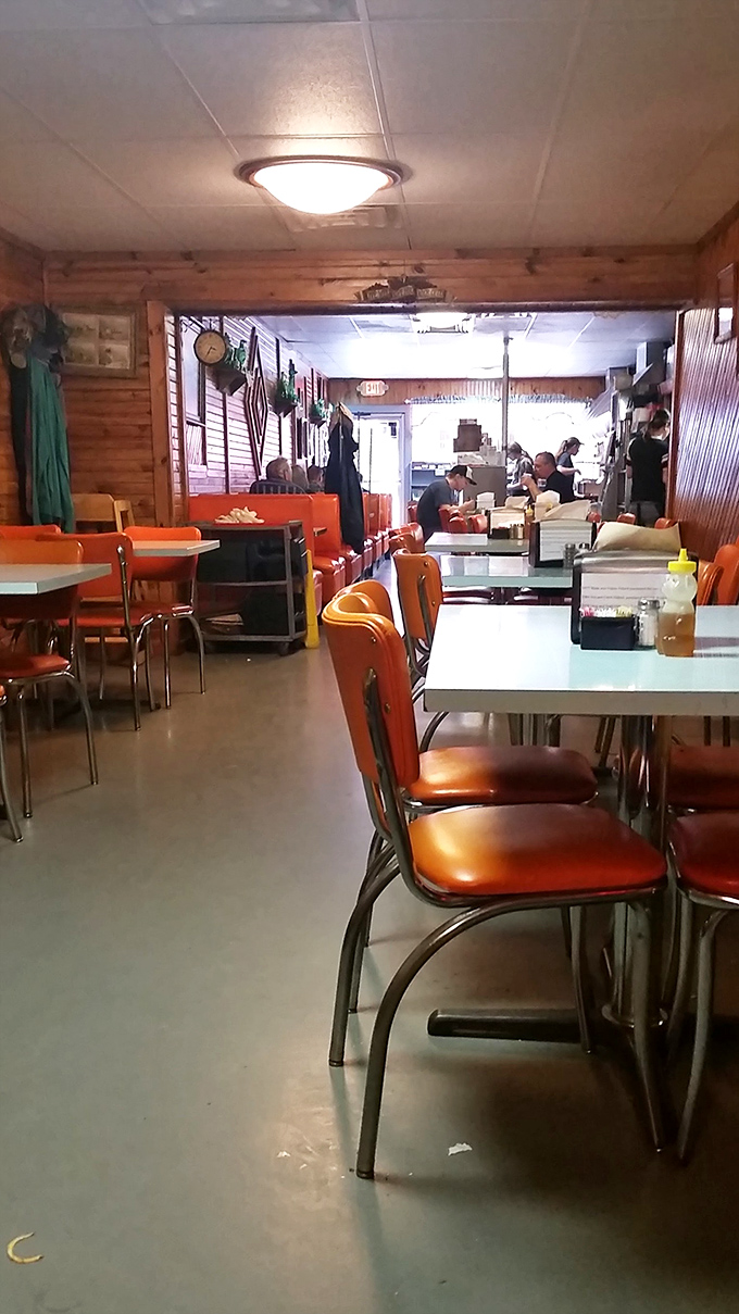 Classic orange vinyl chairs and wood-paneled walls create the perfect small-town symphony. This isn't retro by design&mdash;it's authentic by persistence.