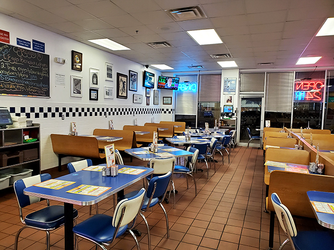Classic blue vinyl booths and checkerboard trim create that timeless diner atmosphere where conversations flow as freely as the coffee. Norman Rockwell would feel right at home.