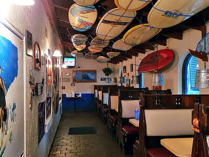 Surfboards suspended from the ceiling create the perfect "beach meets barbecue" vibe. It's like the waves and smoke decided to become best friends.