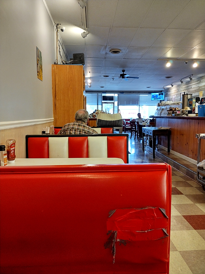 Red and white booths tell stories of countless meals shared. The checkerboard floor and well-worn seats aren't trendy design choices&mdash;they're badges of authentic diner honor.