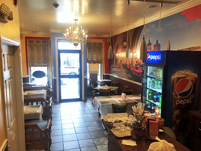 Chandeliers cast a warm glow over simple tables where culinary magic happens. Grandma's dining room never looked this inviting.