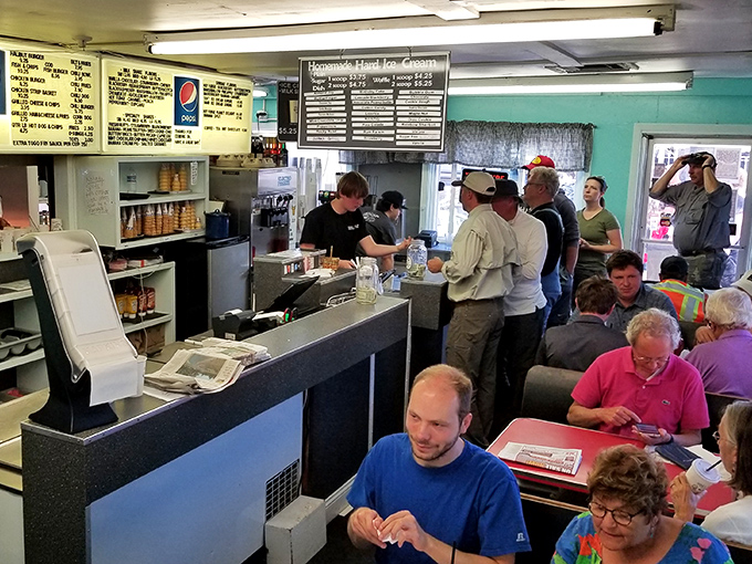 Inside, time stands still as hungry patrons crowd the counter, where the menu board's handwritten charm hints at delicious simplicity ahead.
