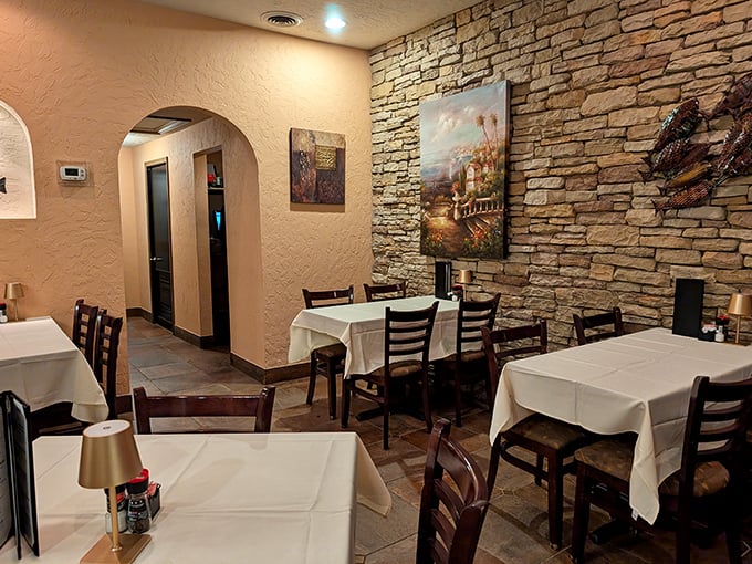 Stone walls and white tablecloths create that perfect balance of rustic charm and dining elegance. Comfort meets class in every corner.
