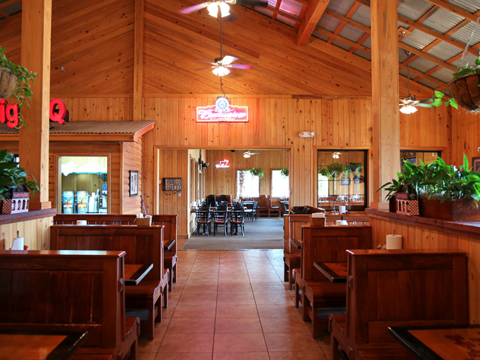Wooden booths and warm pine paneling create that perfect "come as you are, stay as long as you want" vibe that every great BBQ joint needs.