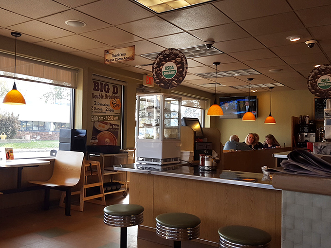 The orange pendant lights cast that magical glow where everyone looks like they've made good life decisions. Classic counter seating invites solo diners to become part of the Little Diner family.