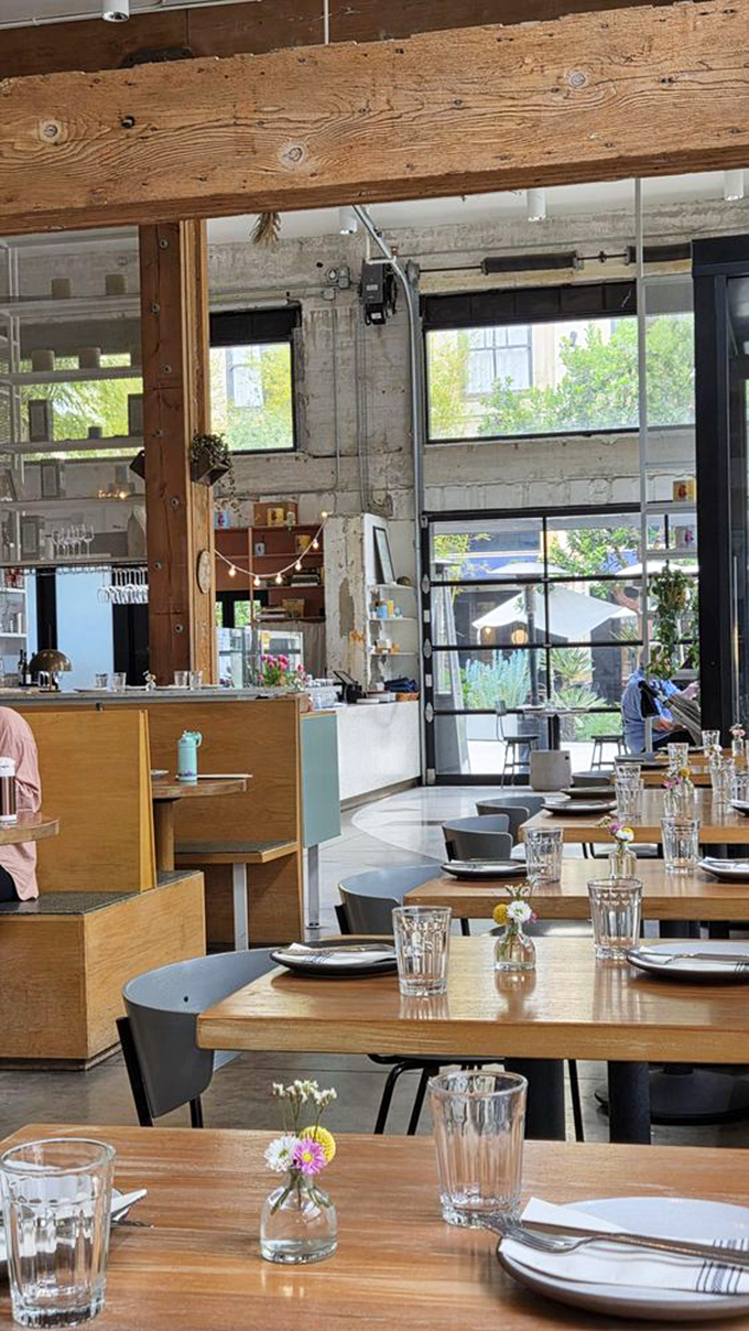 Sunlight streams through floor-to-ceiling windows, illuminating wooden beams and minimalist tables. This isn't just dining&mdash;it's a cathedral of carbs.