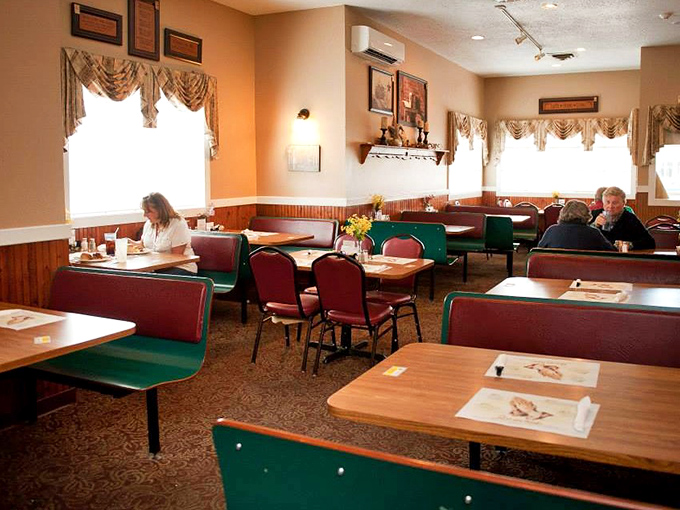 Classic green booths and simple wooden tables create the perfect backdrop for conversations that flow as easily as the coffee refills.