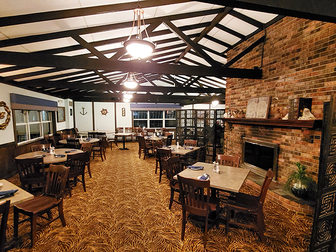 Exposed beams, brick fireplace, and nautical touches create a dining room that feels like a cozy New England seafood haven transported to Pennsylvania.