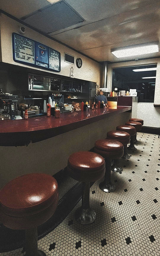 Inside, the classic counter with its row of spinning stools invites you to belly up for a burger experience that hasn't changed since your parents' first date.