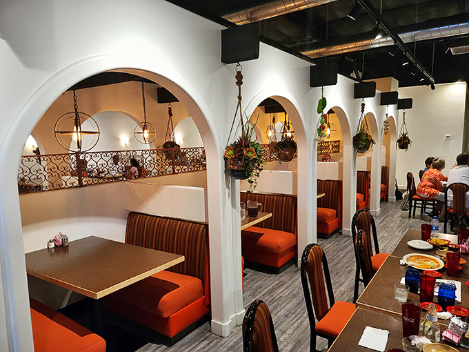 Those distinctive arched booths create intimate dining spaces where green chili magic happens daily.