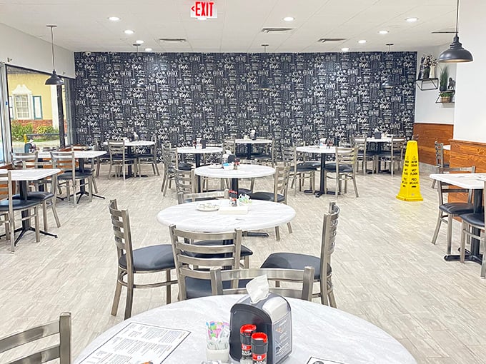 Modern meets nostalgic in this thoughtfully designed dining space. That feature wall isn't just decoration&mdash;it's a visual menu teasing what awaits your taste buds.