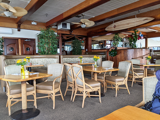 Tropical plants, wooden beams, and surfboards overhead create that perfect coastal vibe where comfort meets California cool.