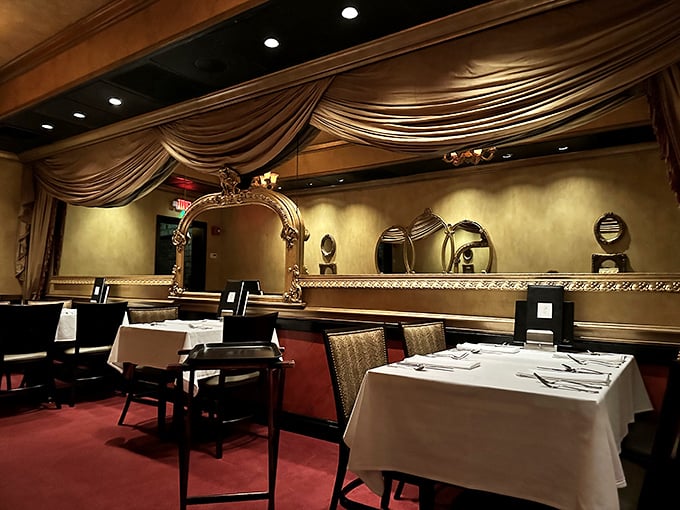 Old-world elegance meets theatrical dining. The gold mirrors and draped fabrics create an atmosphere where James Bond wouldn't look out of place ordering a martini.