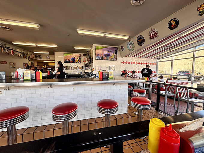 Classic diner vibes with a modern twist. Those red counter stools aren't just for show—they're front-row seats to burger artistry in action.