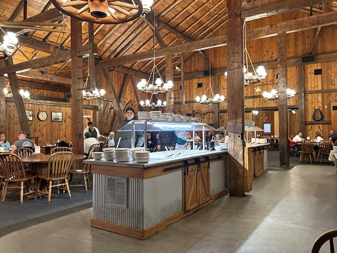 Rustic wooden beams and wagon wheel chandeliers create an authentic barn atmosphere that's both grand and cozy&mdash;like dining in a Norman Rockwell painting come to life.