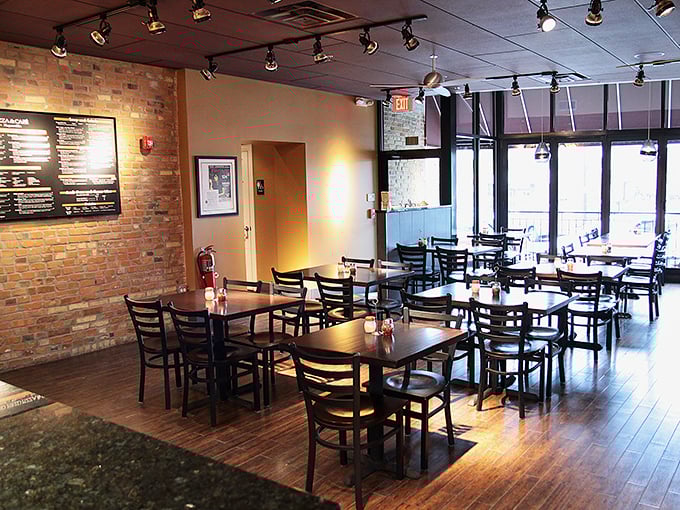 Simple wooden tables and exposed brick walls create the perfect backdrop for pizza drama to unfold. No distractions, just anticipation.