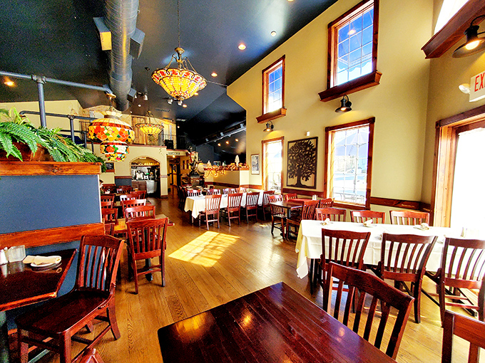 Hardwood floors and Tiffany-style lamps create the perfect backdrop where comfort food meets sophisticated dining dreams.