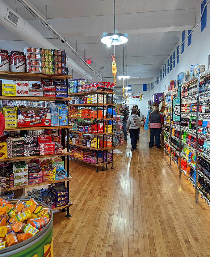 Candy corridors stretch toward sweet infinity, where wooden floors creak beneath the weight of countless sugar-seeking pilgrimages.