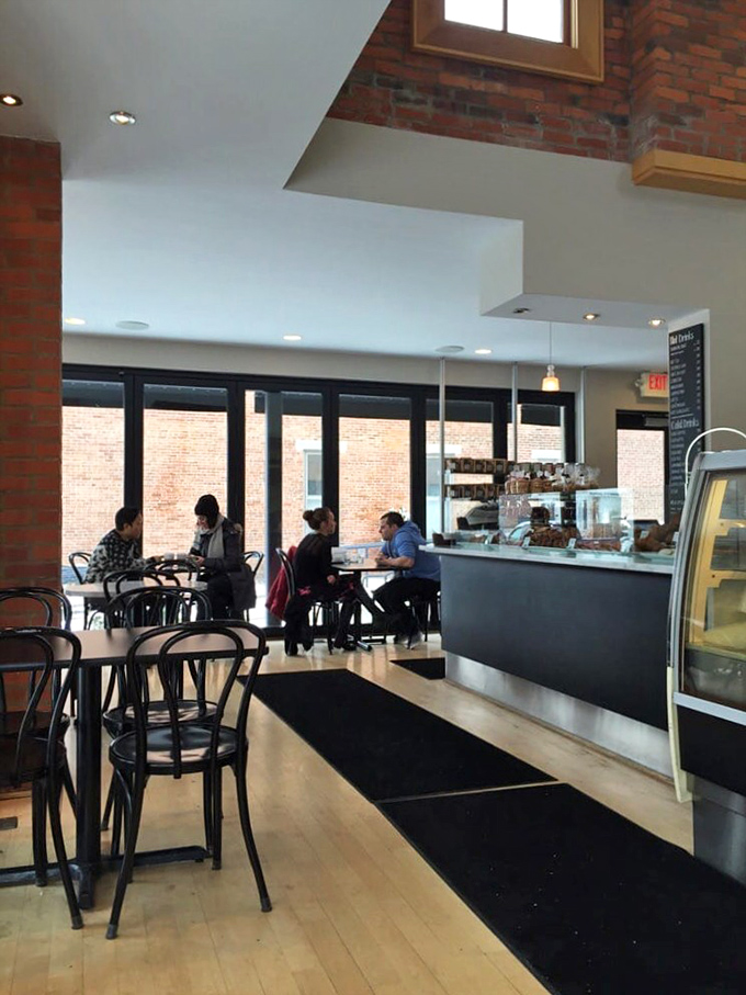 Inside, exposed brick meets modern elegance in a space that feels both sophisticated and welcoming&mdash;like your stylish friend's apartment, if your friend happened to be a master baker.