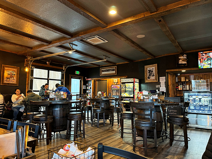 Barrel tables and exposed beams create a rustic charm that says "stay awhile." The kind of place where coffee refills appear magically.