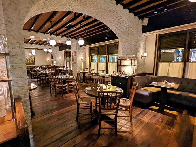 Step inside and the world slows down. Exposed brick arches and warm wooden beams create that rare atmosphere where memories are made before the first bite.