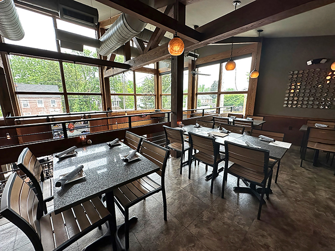 Industrial-chic meets cozy comfort in this thoughtfully designed dining space where wooden beams and natural light create the perfect backdrop for culinary magic.