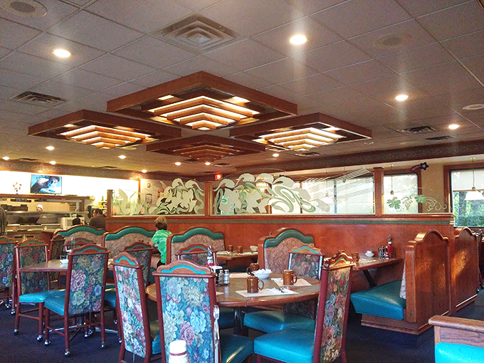 Classic diner aesthetics meet cozy comfort with those distinctive tiered ceiling lights. The floral upholstery isn't trying to be retro&mdash;it just never left, thank goodness.