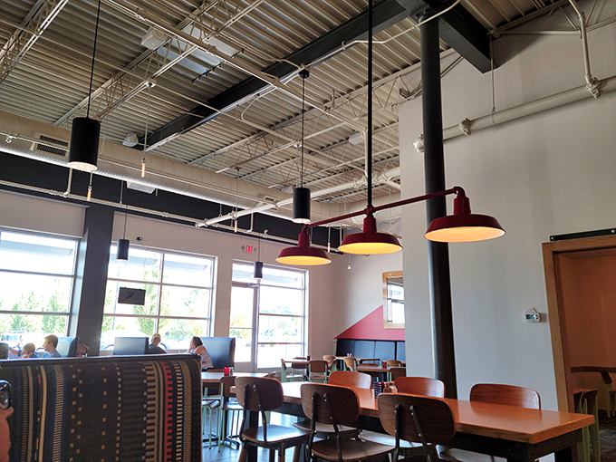 Industrial-chic meets cozy comfort under those signature red pendant lights, where conversations flow as freely as the gravy.