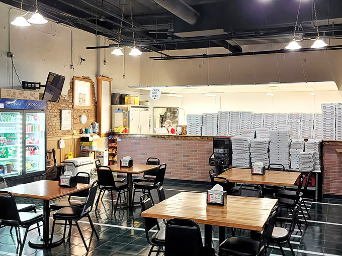 Simple wooden tables, practical chairs, and stacks of pizza boxes ready for action&mdash;this is a place that puts substance over style.